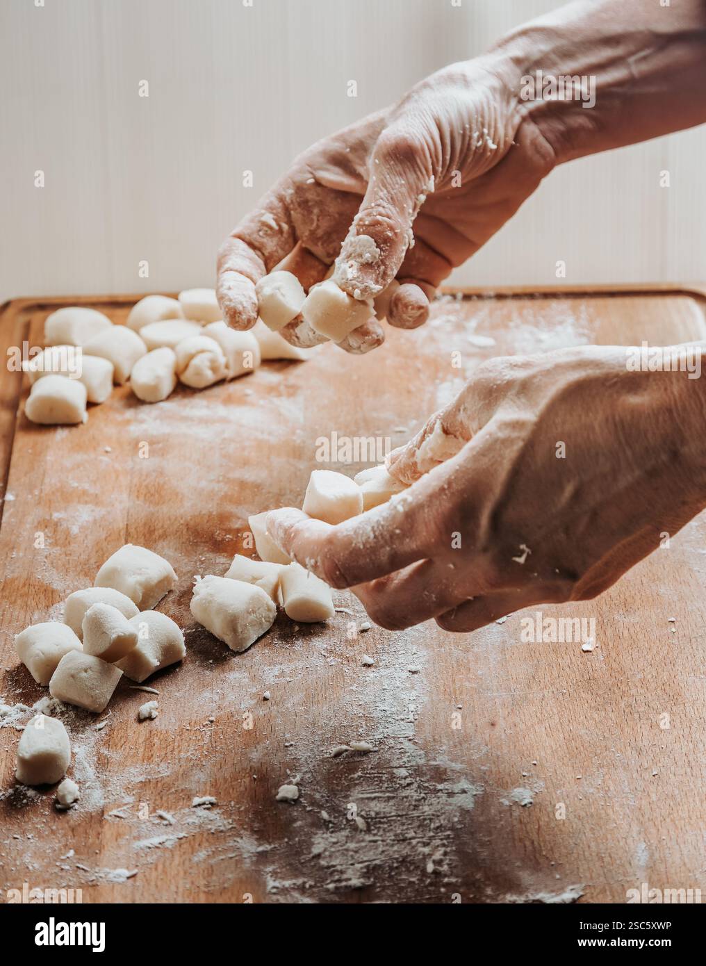 Homemade pasta preparation in Tuscany. The image shows the hands of a ...