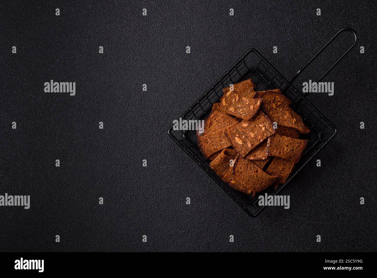 Crispy homemade brown bread chips with seeds and grains, salt, spices ...