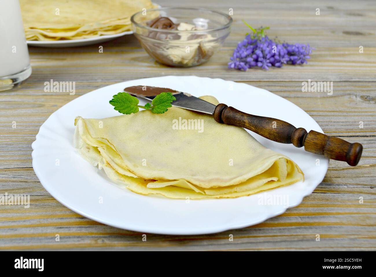Folded pancake, chocolate spread and milk Stock Photo - Alamy