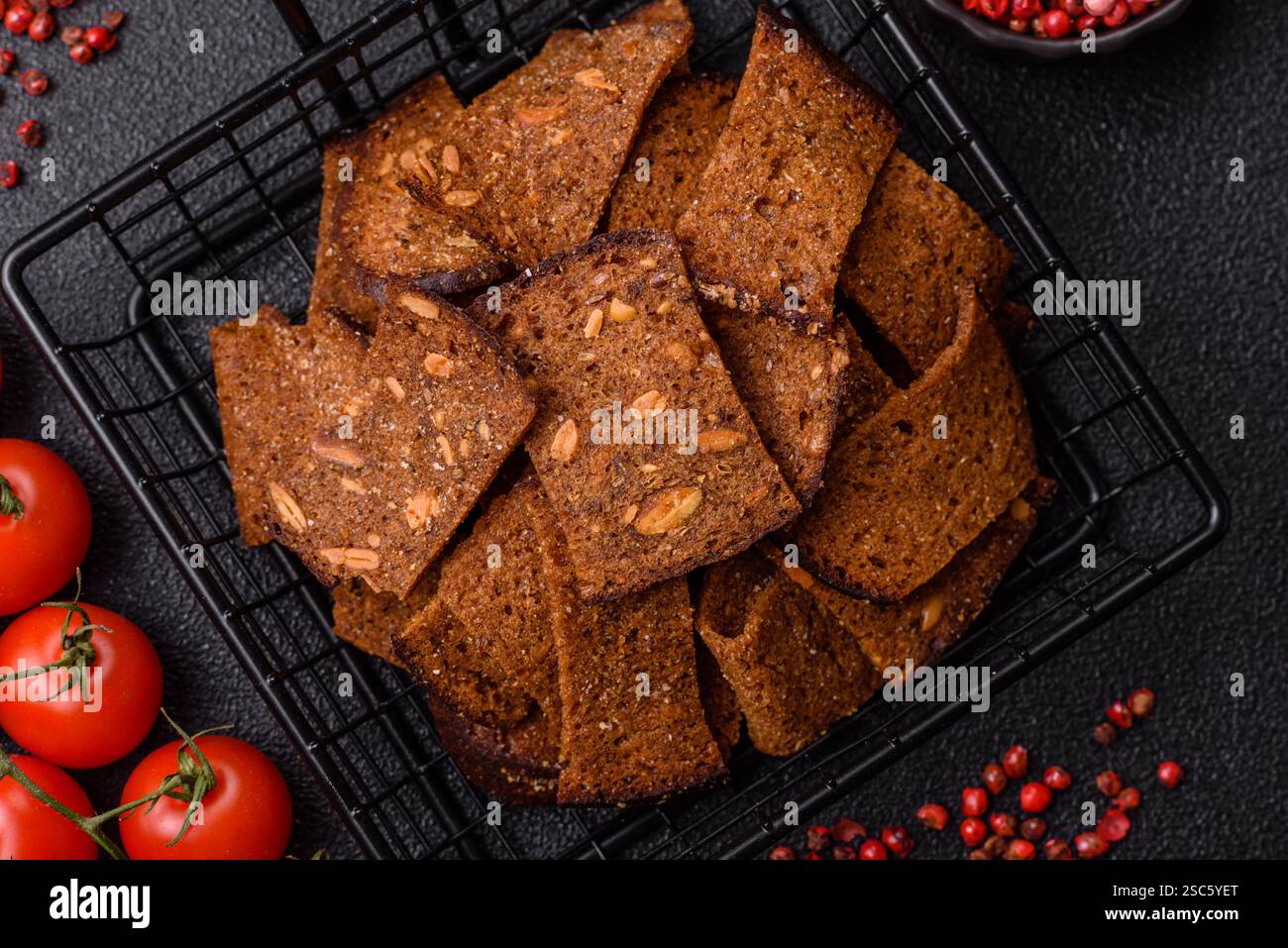 Crispy homemade brown bread chips with seeds and grains, salt, spices ...
