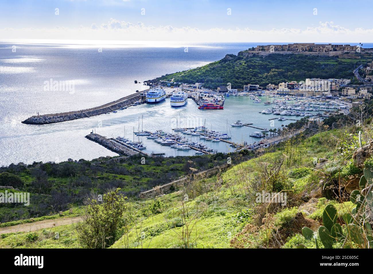 View from hill on harbour basin of Gozo Mgarr Harbour with small boats ...