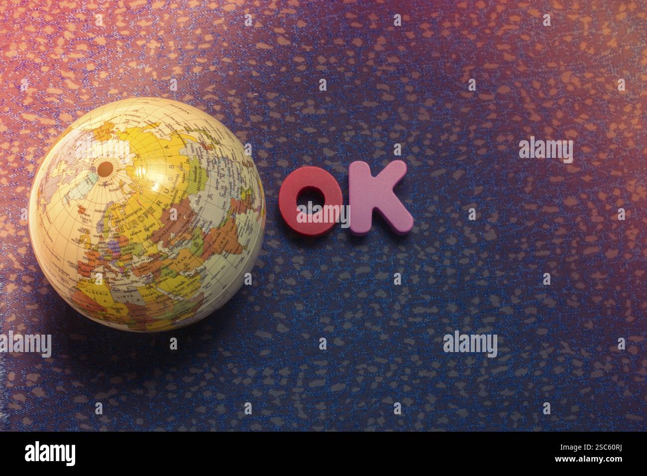 Mini globe model beside word OK with letter blocks Stock Photo - Alamy