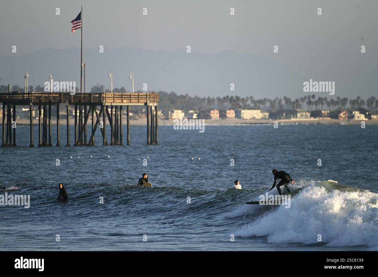 Surfers in the Pacific Ocean, on the beach in Ventura, California, USA ...