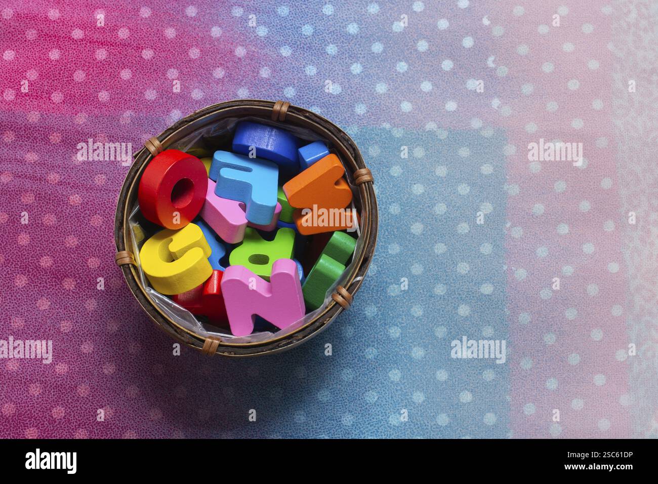 Colorful wooden letters in a container on a colorful background Stock ...
