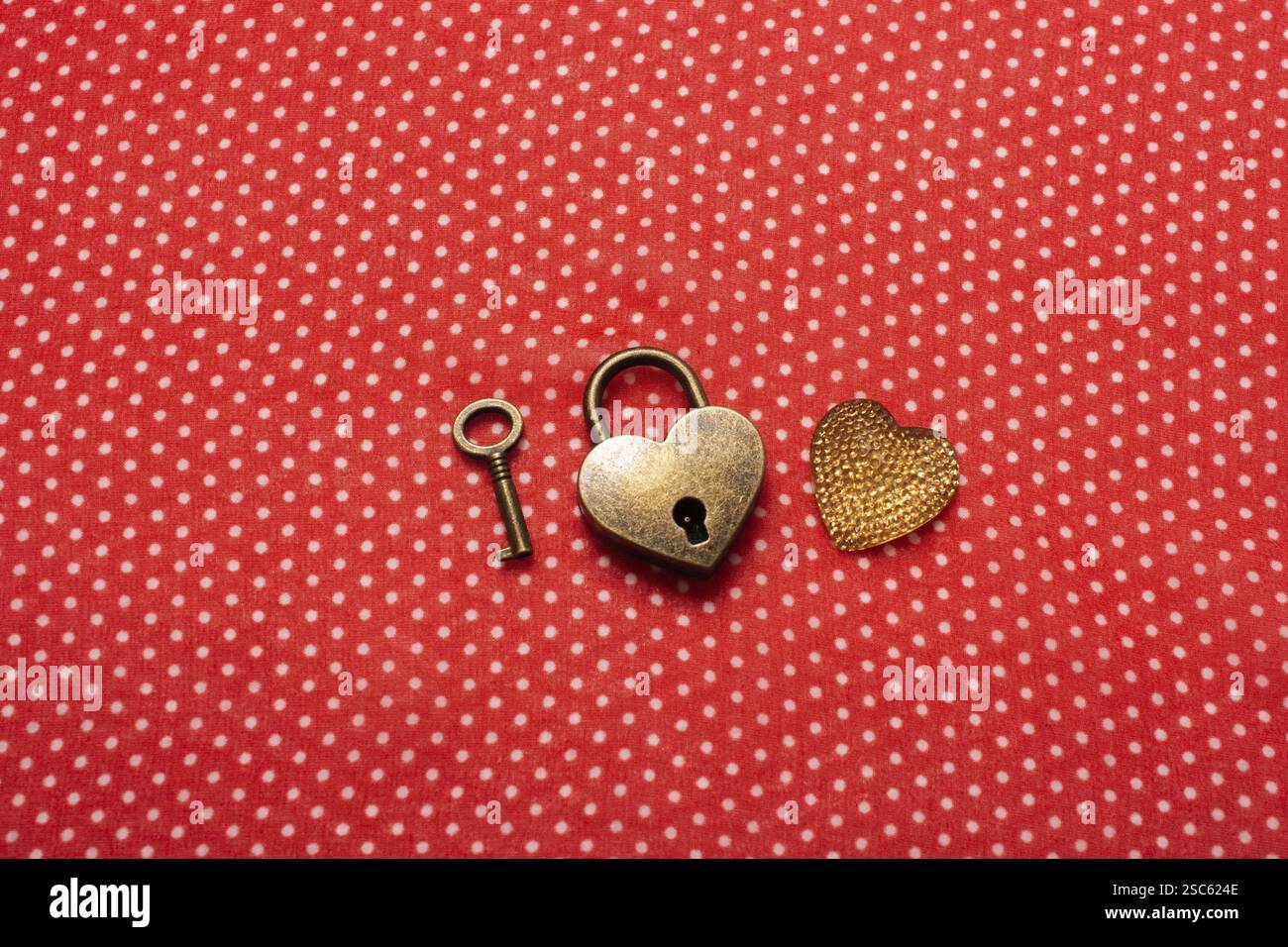 Heart shaped lock and key on a red background Stock Photo - Alamy