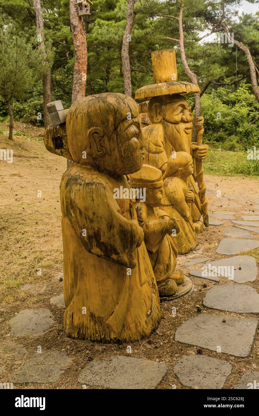 Geosan, South Korea, August 26, 2020: Side view of carved wood statues ...