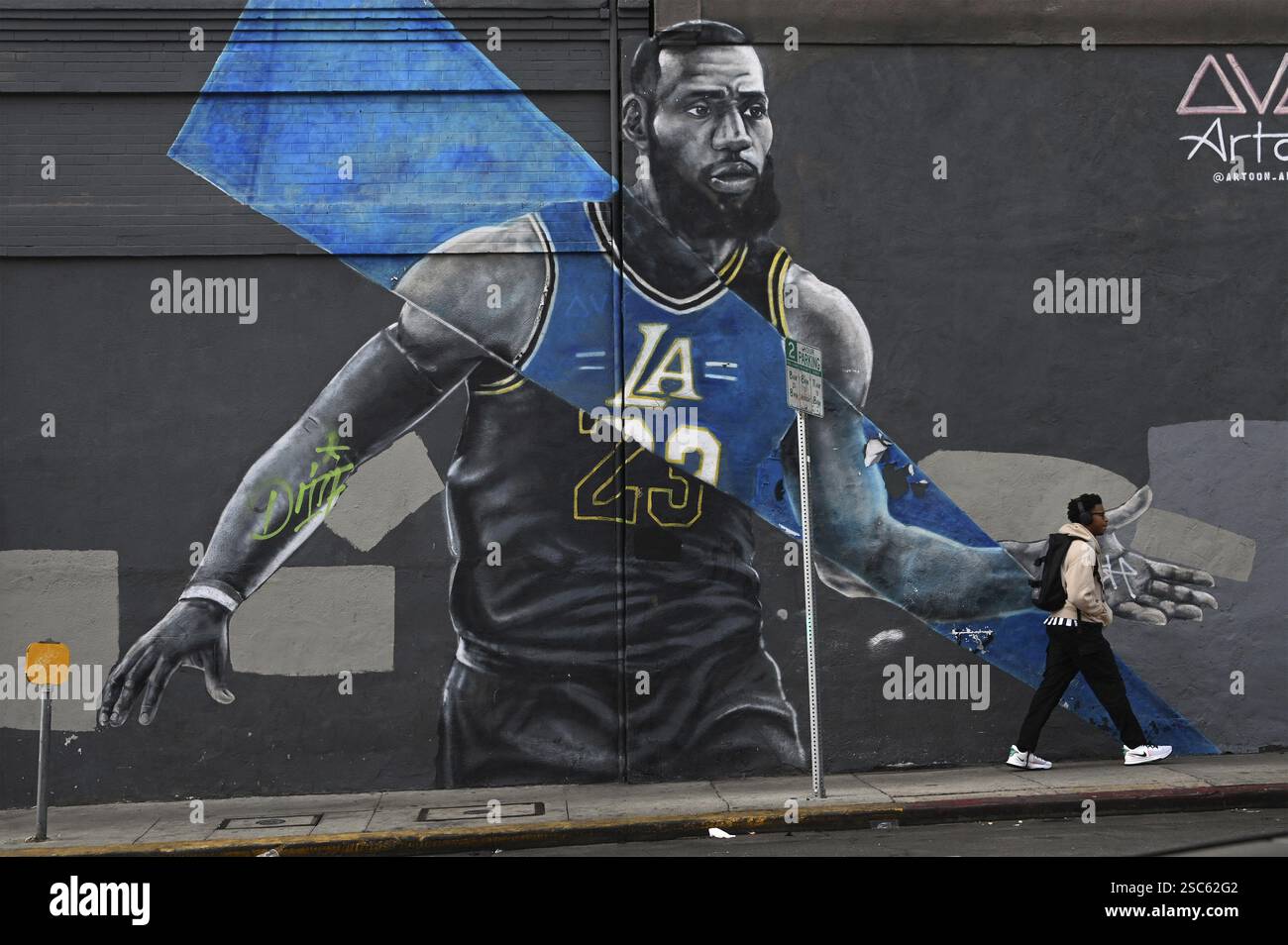 Passer-by in front of a mural of basketball player LeBron James ...