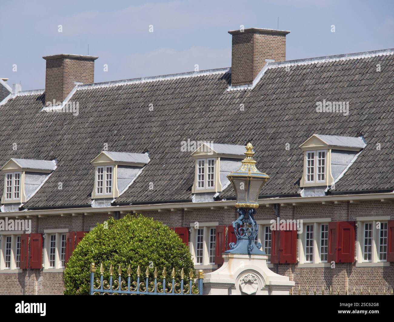 Historic building with pitched roof and skylights under a clear blue ...