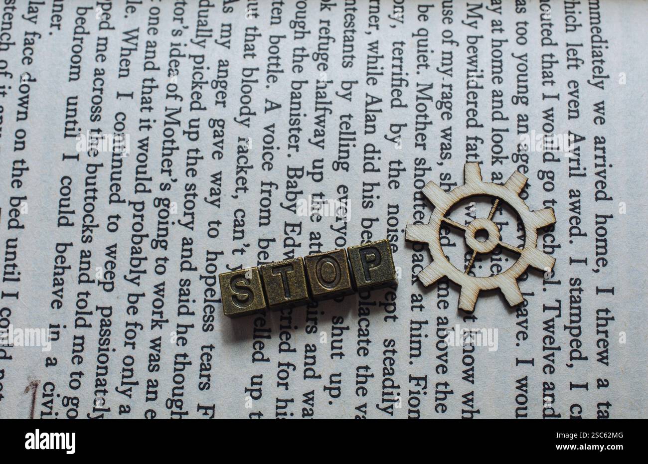 Stop wording and industry mechanism cogwheels on book page Stock Photo ...