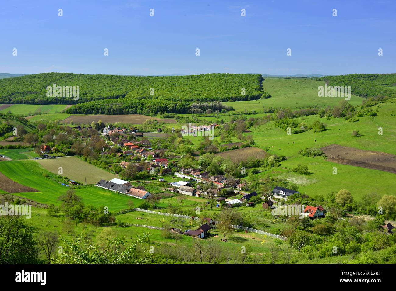 Spring panorama of Maiad in the valley surrounded by green hills in ...