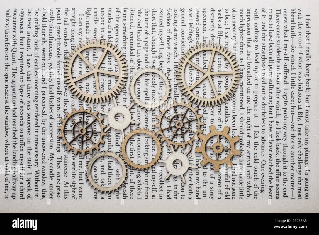 Wooden cogwheels on a page of a book. Industry concept information ...