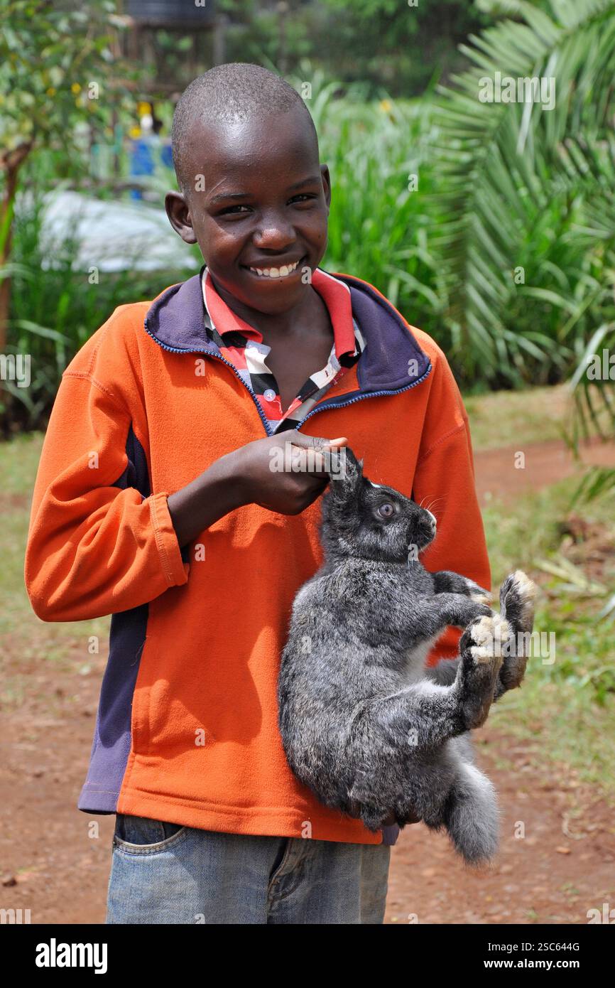 Kenya. Nairobi. Kamiti Village. Boy With Rabbit Stock Photo - Alamy