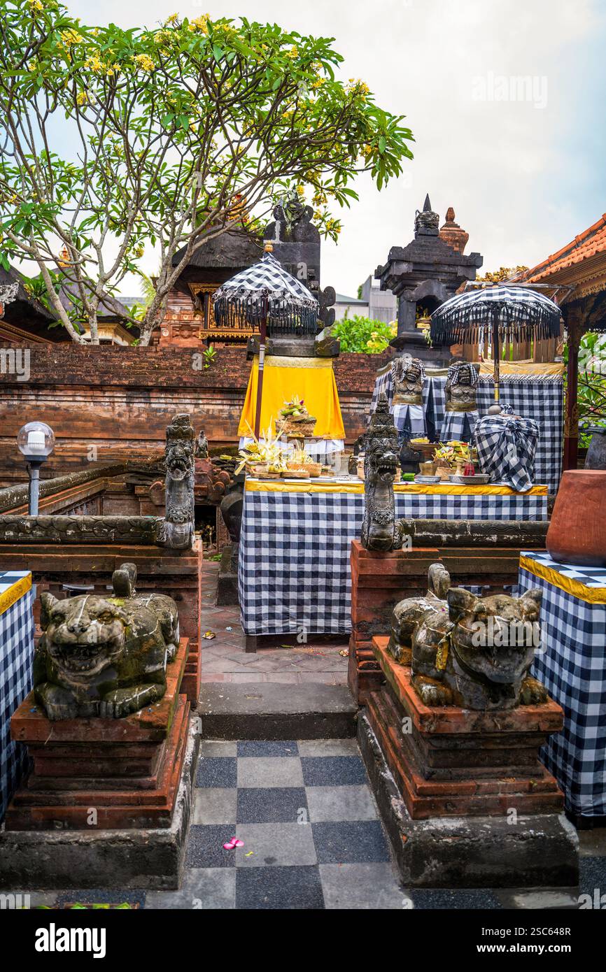 A traditional Balinese shrine featuring ornate stone carvings ...