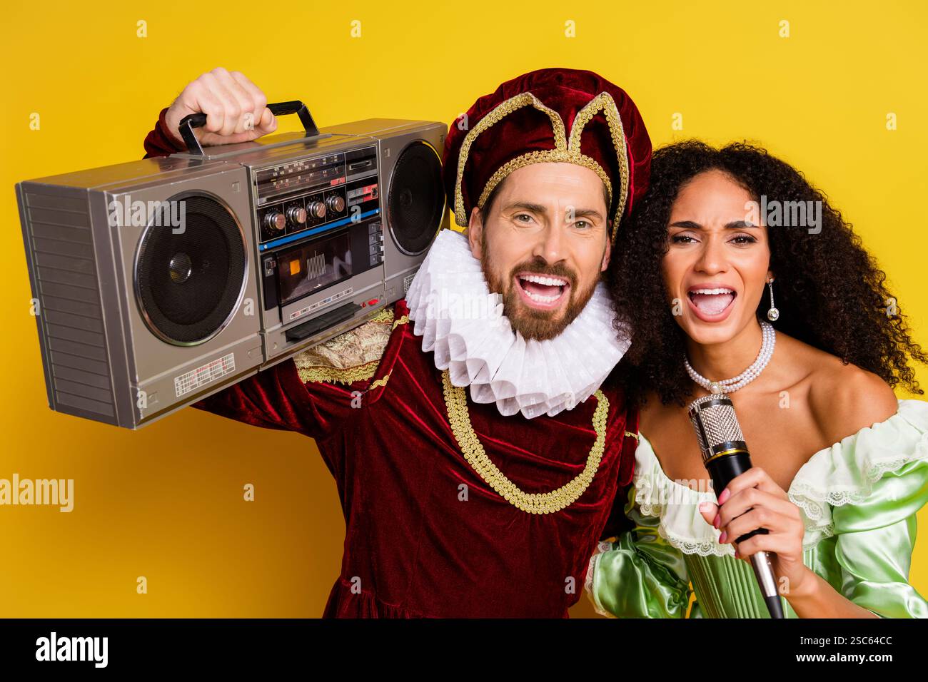 Cheerful Couple in Medieval Costumes Singing with a Boombox on a Bright ...