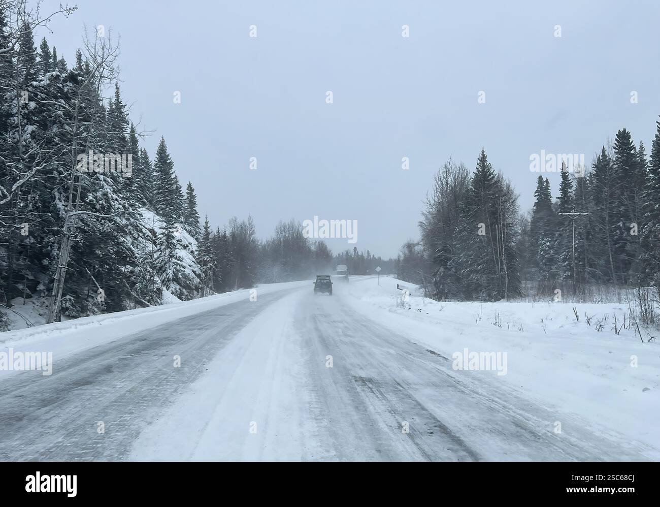Cars driving on icy Richardson Highway between Fairbanks and Delta ...