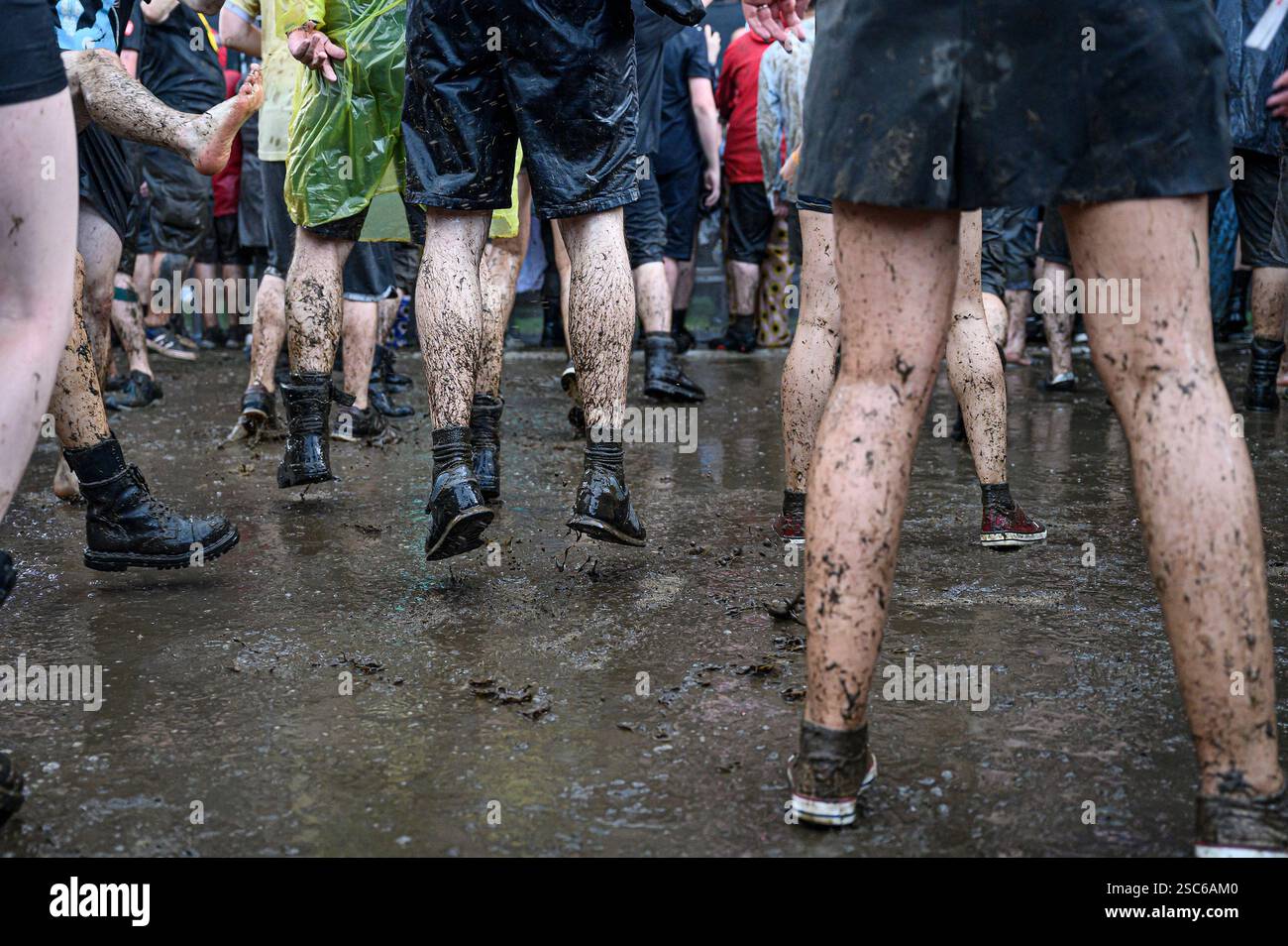 Dirty legs of people dancing in the mud during concert Stock Photo - Alamy