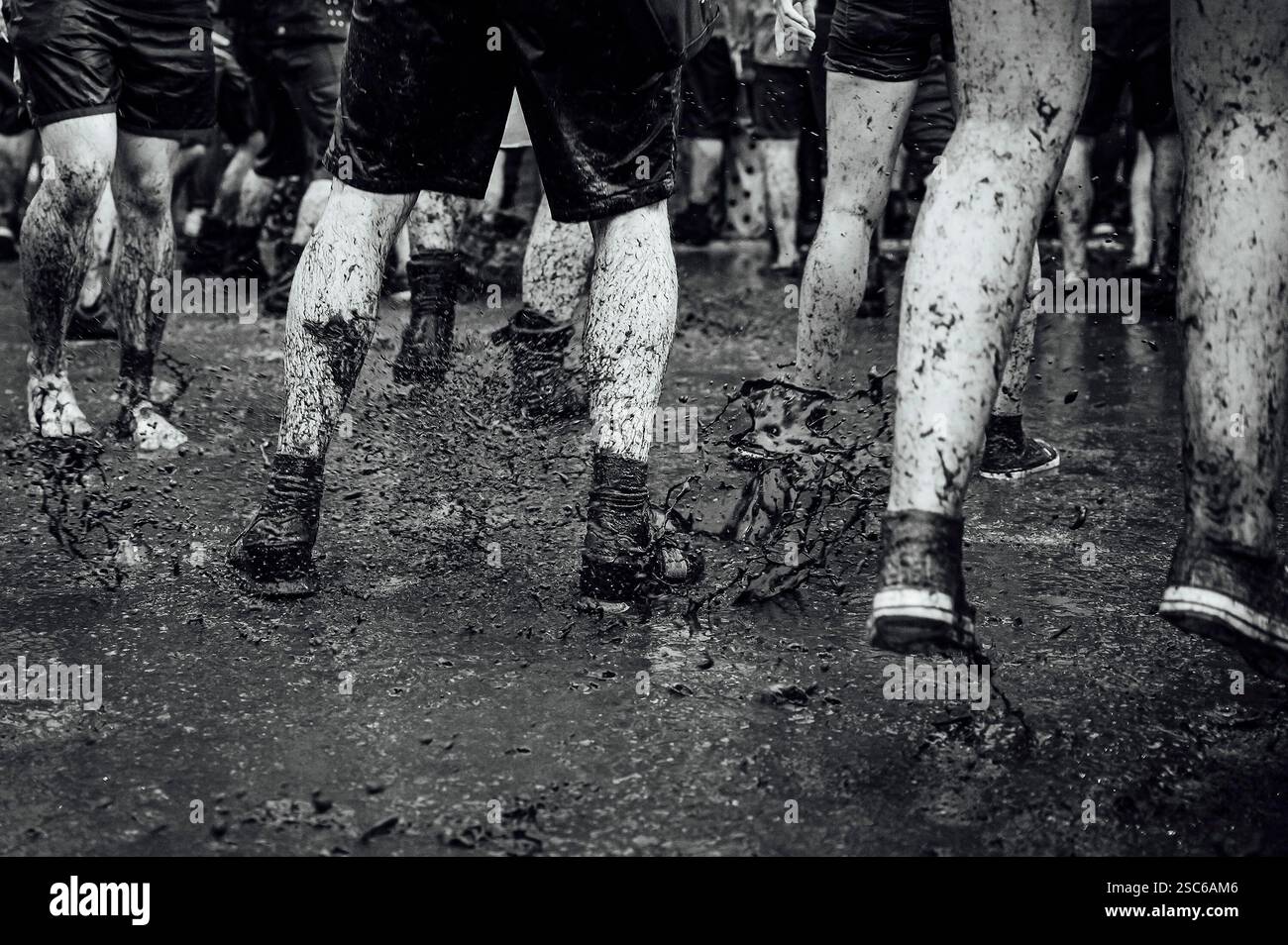 Dirty legs of people dancing in the mud during concert Stock Photo - Alamy