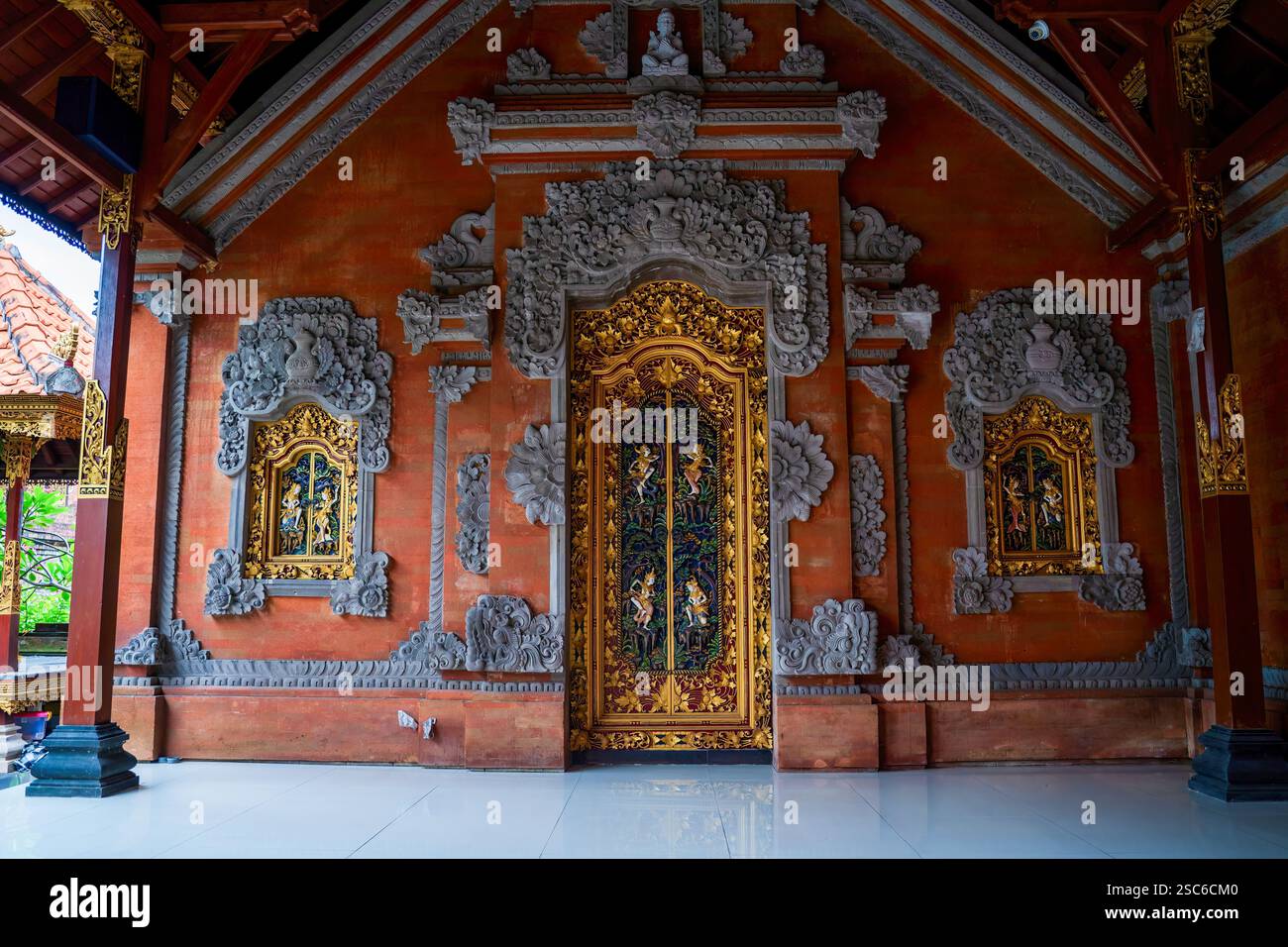 An ornate Balinese temple featuring intricate carvings, vibrant golden ...