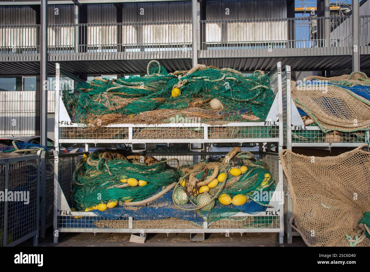 Fishing nets and buoys in storage racks Stock Photo - Alamy