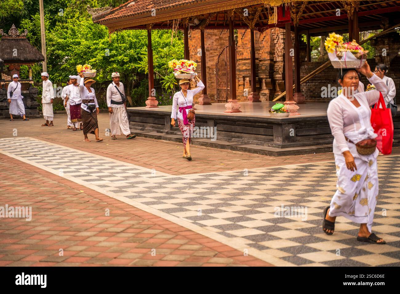 Bali, Indonesia - November 29, 2023: Balinese worshippers carry vibrant ...
