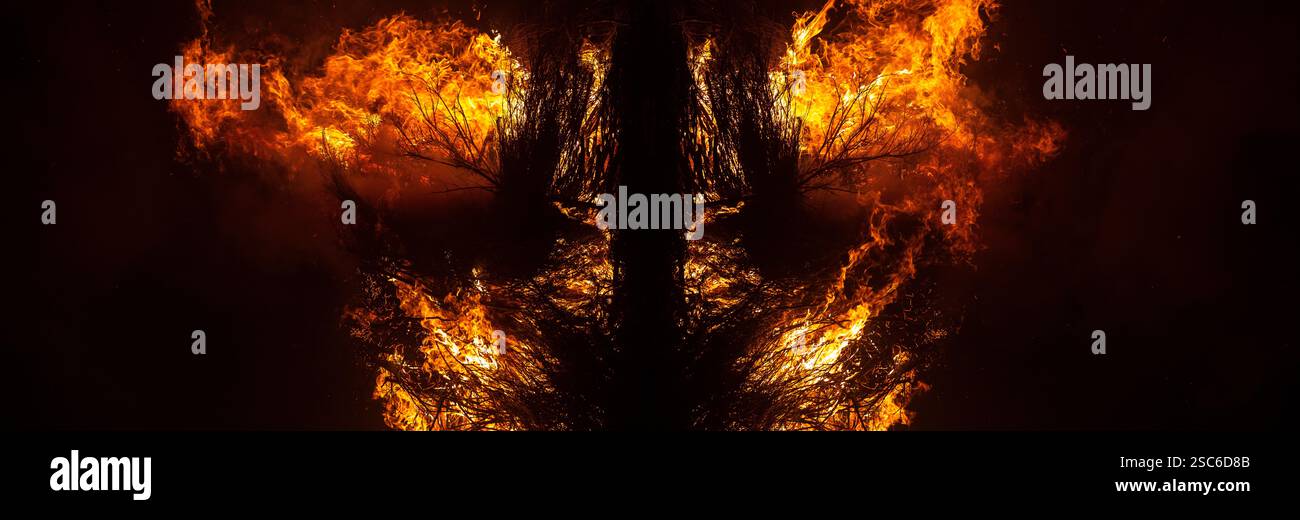 Bonfire close-up details, forming a Evil Face Eyes Stock Photo - Alamy