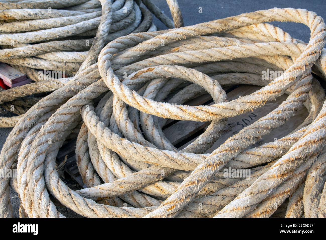 Detailed close-up view of used and frayed maritime ropes, highlighting ...