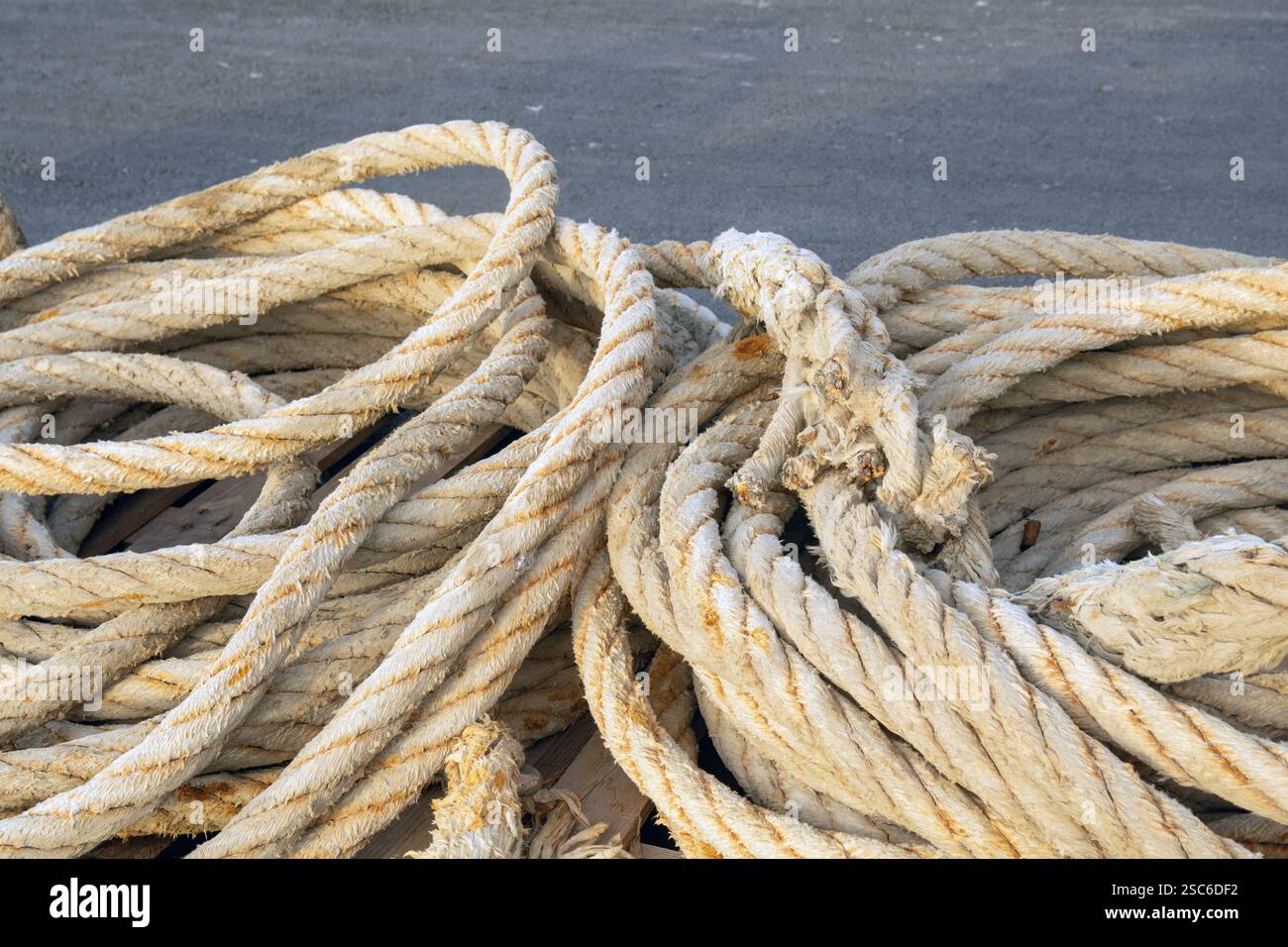 Weathered industrial ropes coiled on pallets Stock Photo - Alamy
