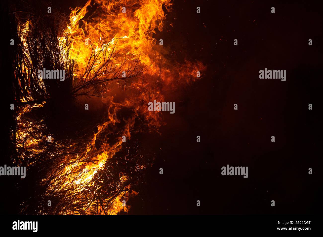Bonfire close-up details, forming a Evil Face Eyes Stock Photo - Alamy