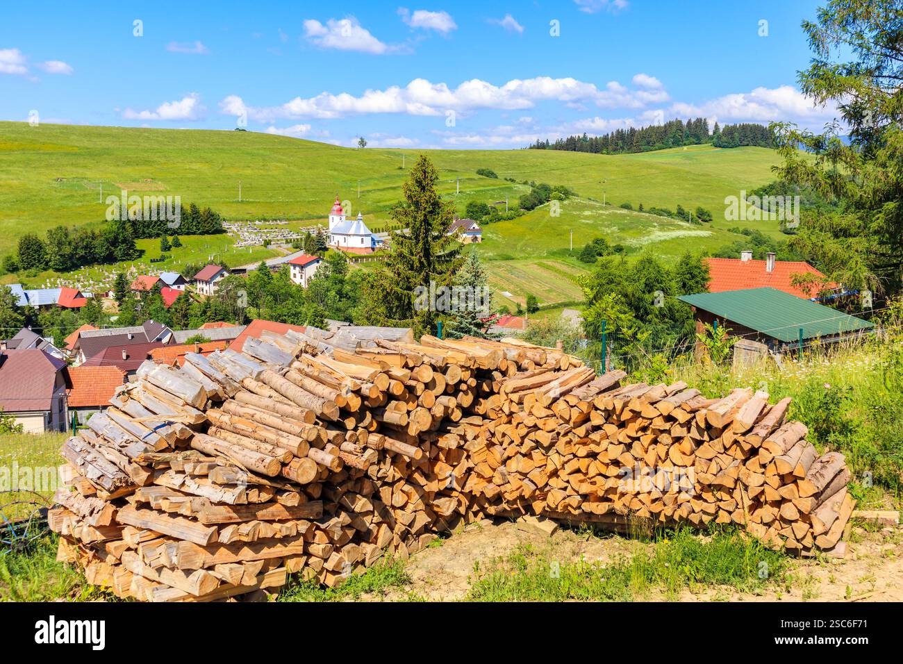 Timber wood and view of Pribis village with houses and church, Orava ...