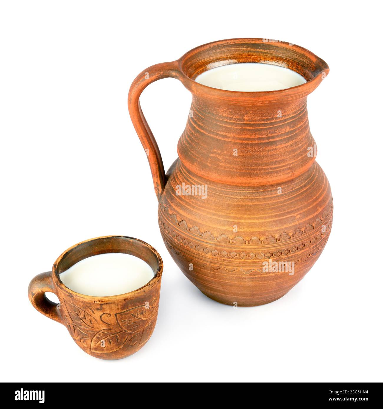 Clay jug and mug with fresh milk isolated on white background Stock ...