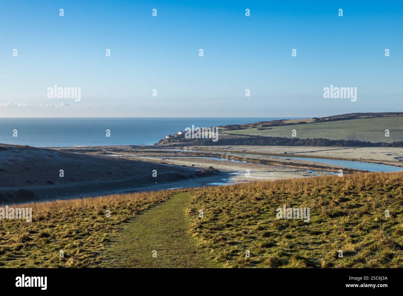 Looking over the Cuckmere Valley in Sussex with a blue sky overhead and ...