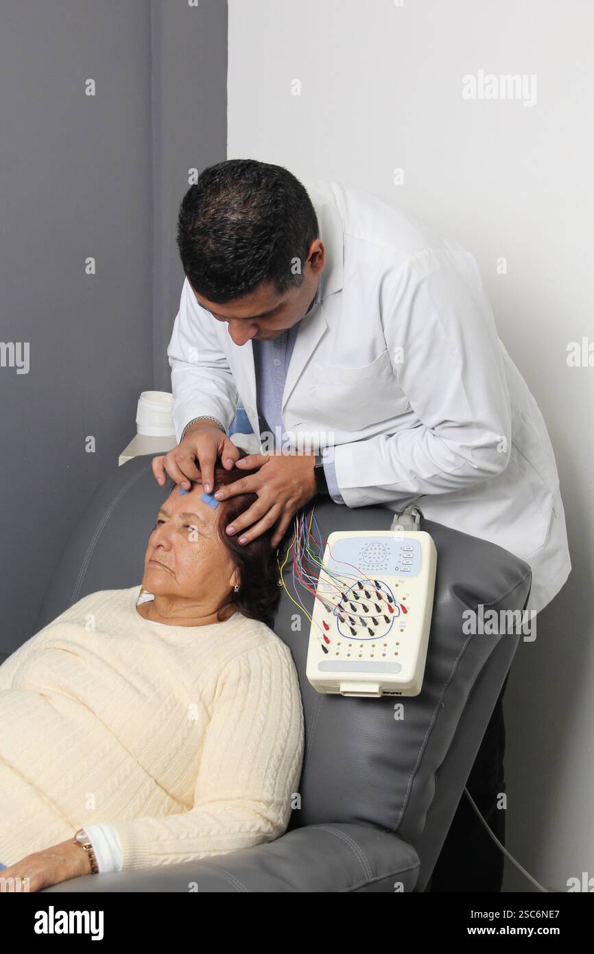 Elderly Latin woman undergoes EEG electroencephalogram to detect ...