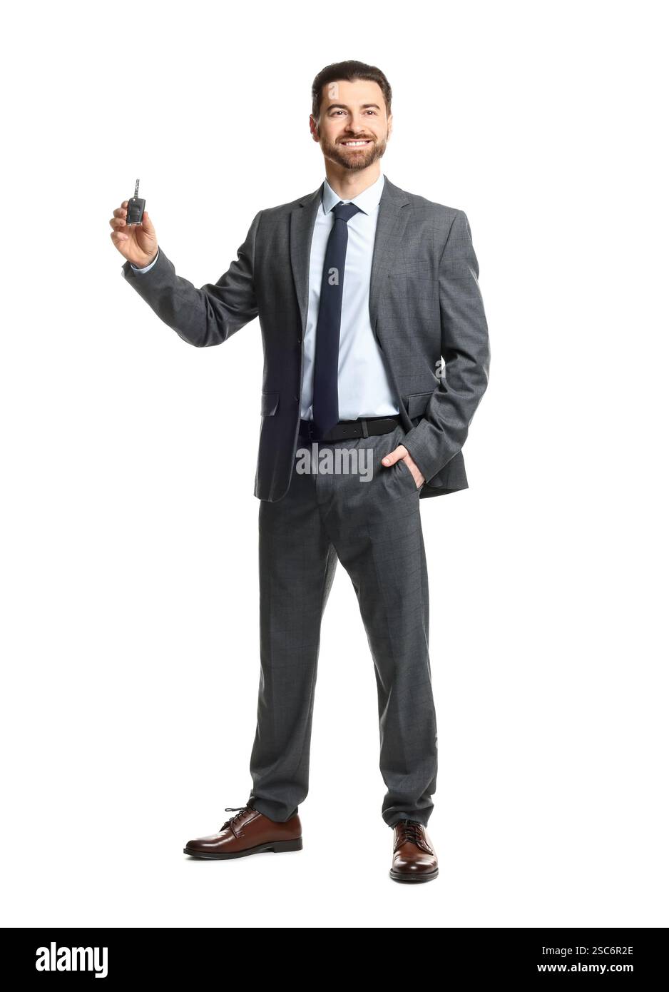 Cheerful salesman with car key on white background Stock Photo - Alamy