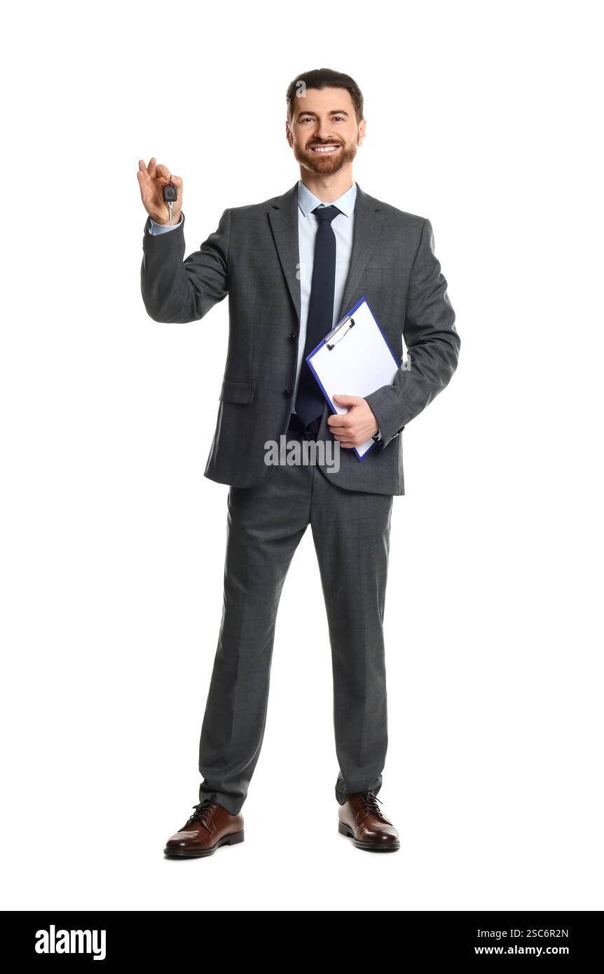 Cheerful salesman with car key and clipboard on white background Stock ...