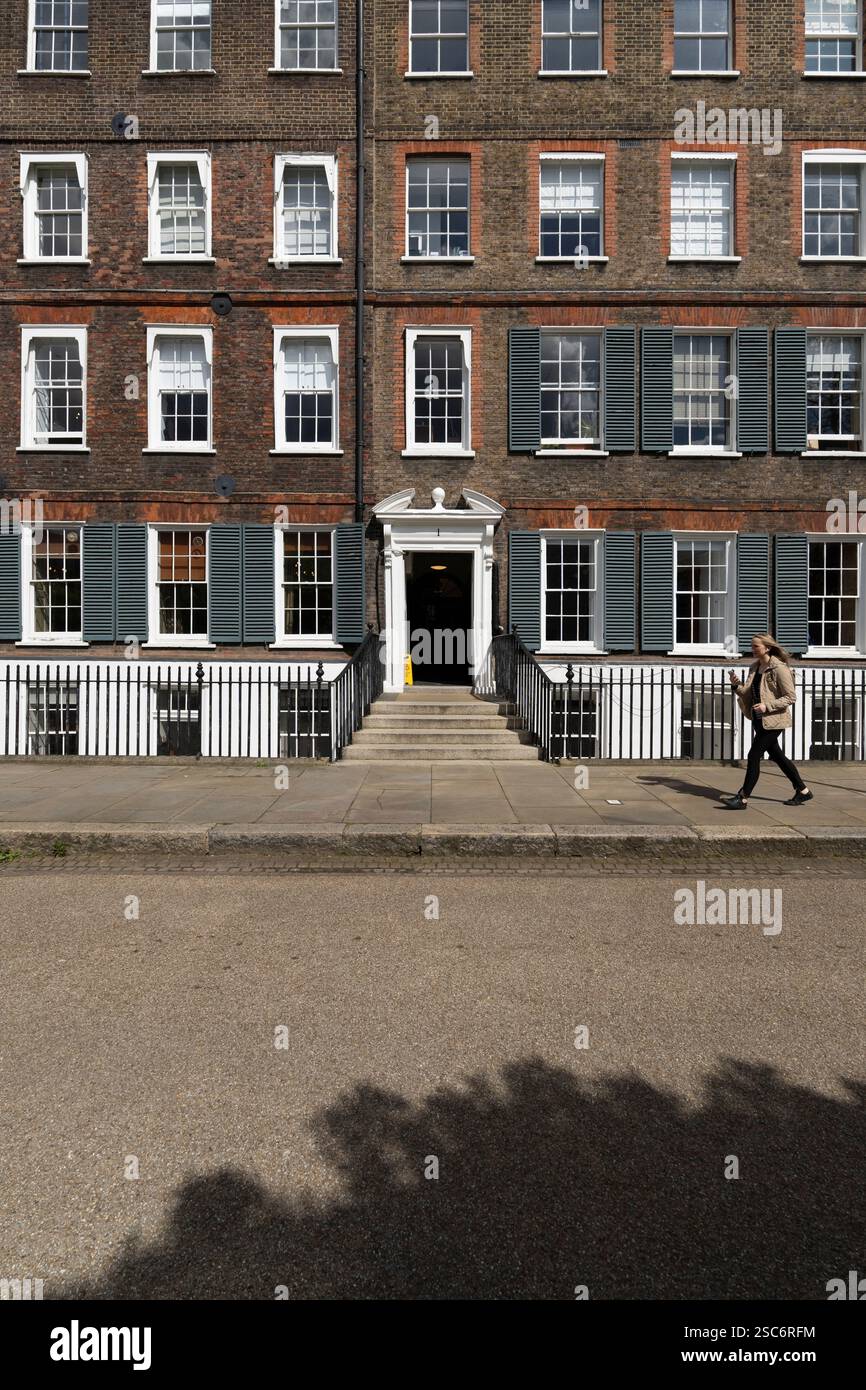 Pedestrian walks past the entrance of No. 1, a historic building on the ...