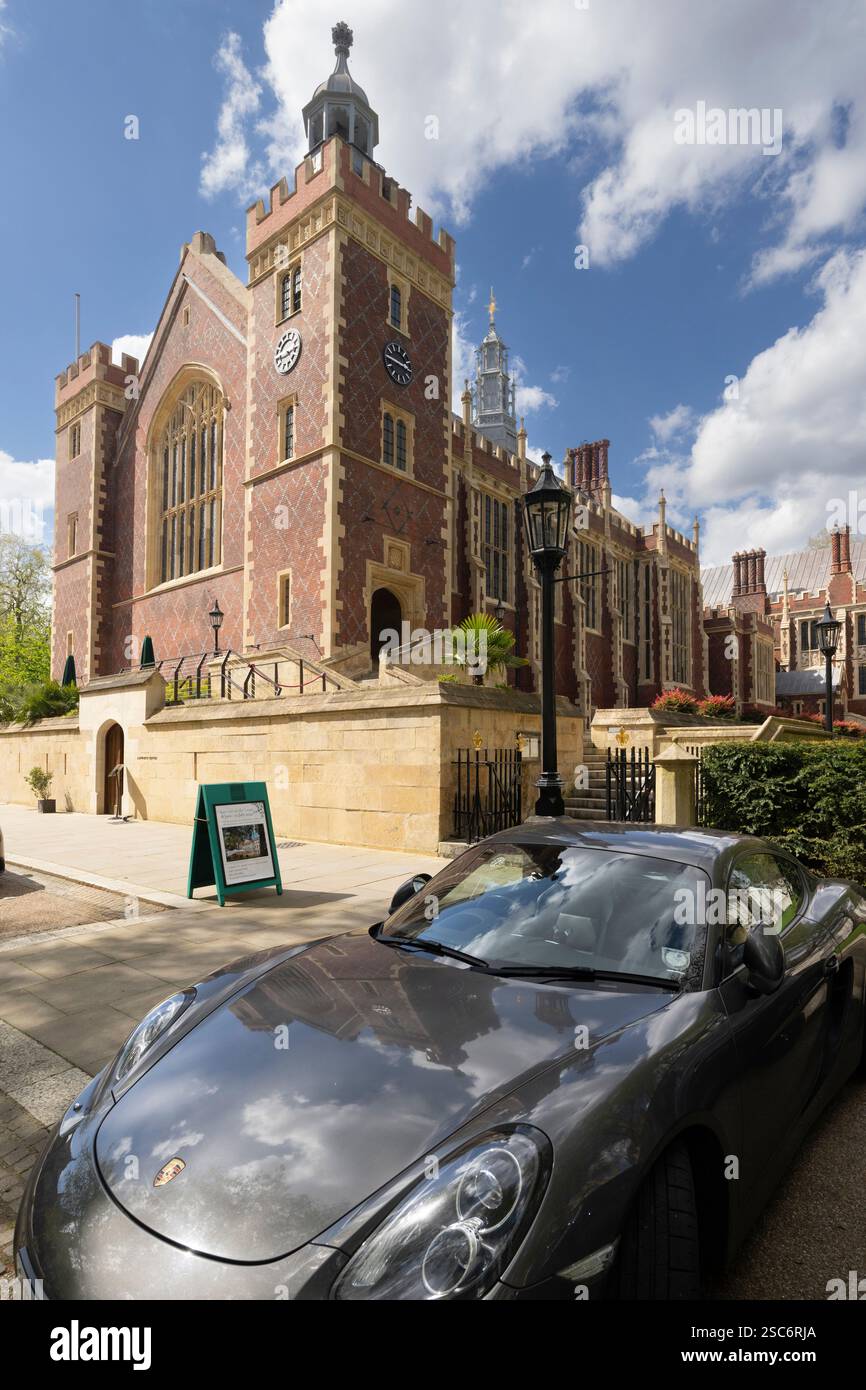 A dark gray Porsche Cayenne sits in front of the historic Old Palace ...
