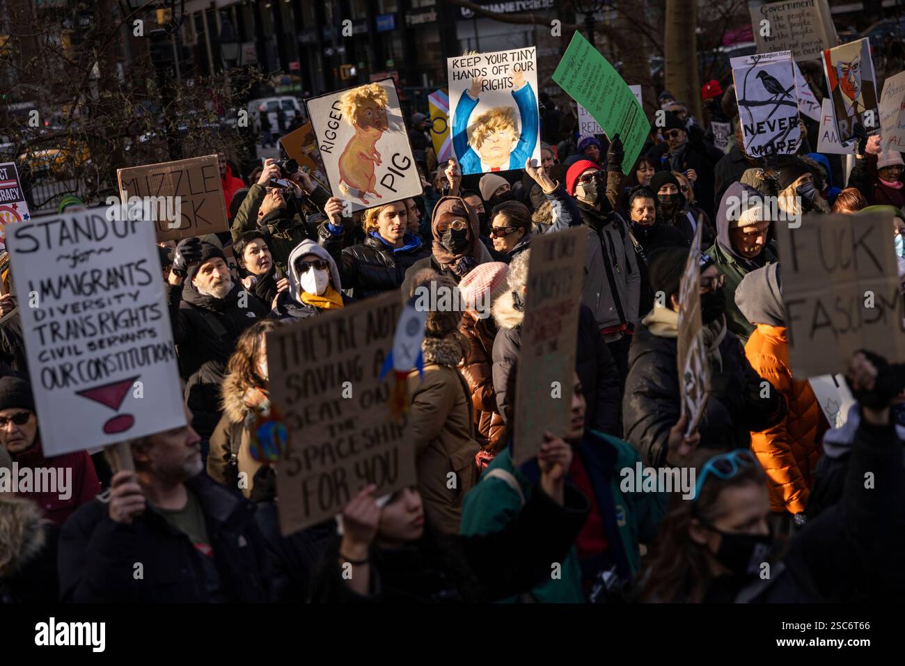 Demonstrators raise signs during a protest outside City Hall, Wednesday ...