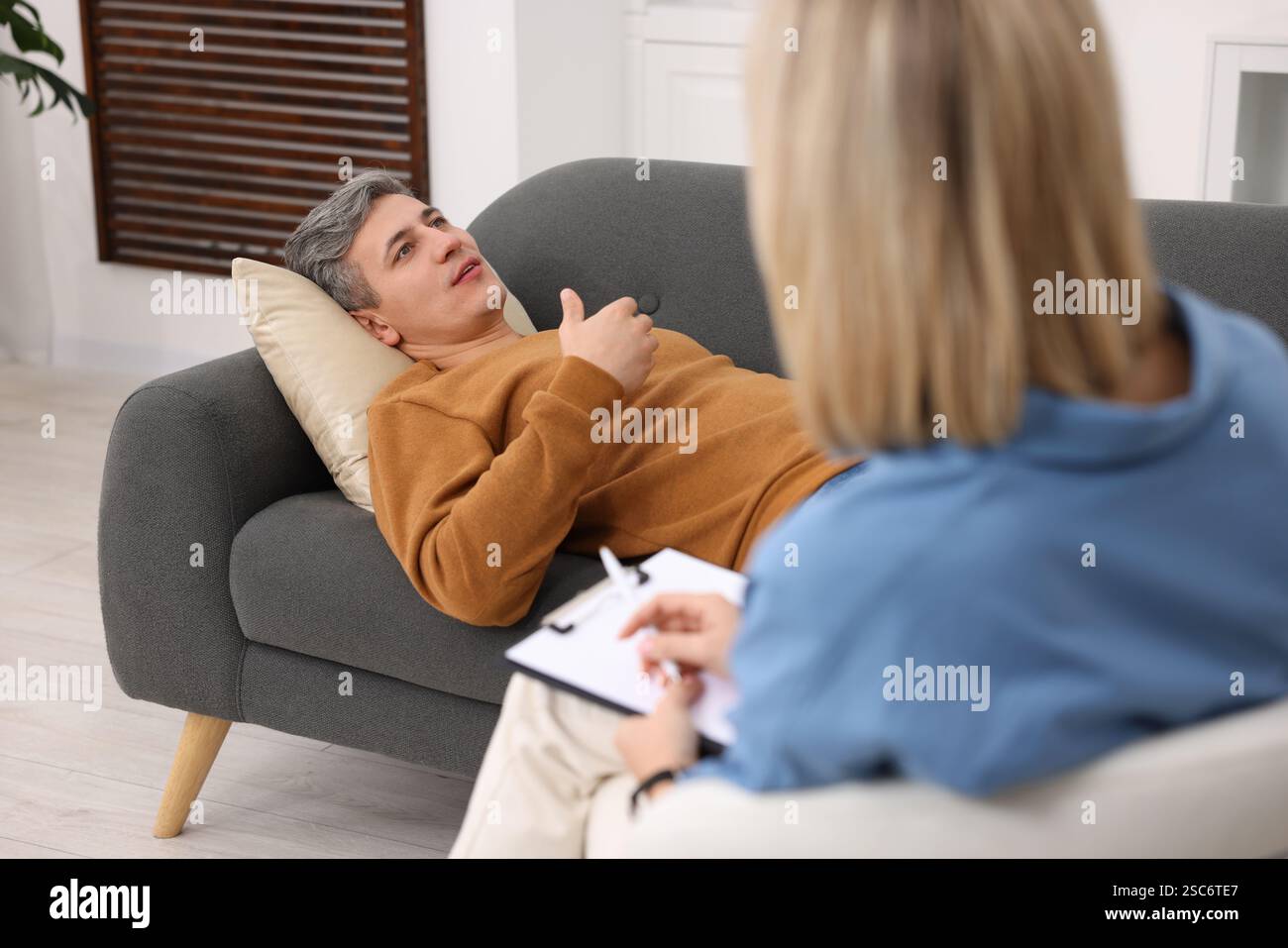Professional psychologist working with patient in office Stock Photo ...