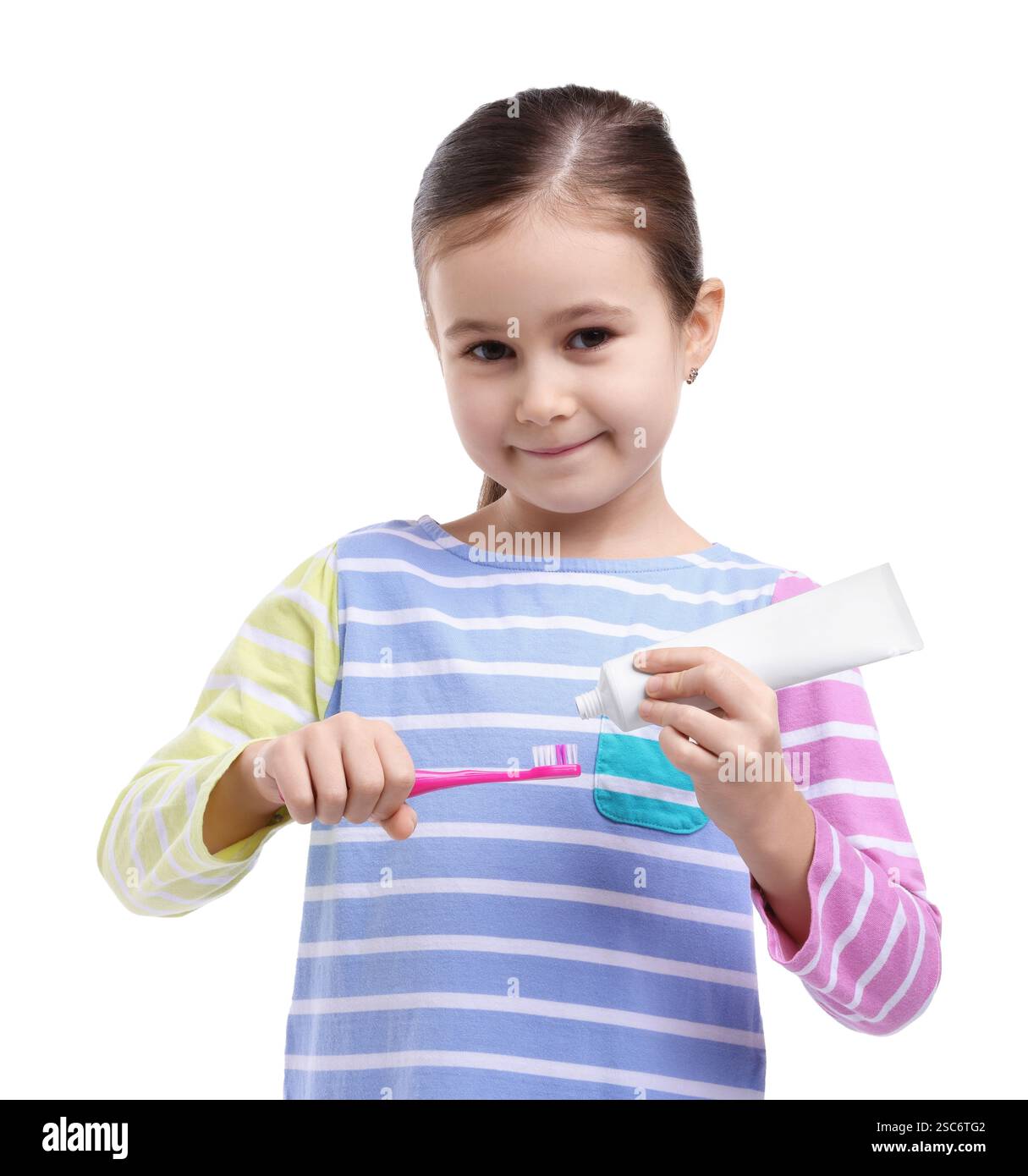 Cute girl applying toothpaste onto toothbrush on white background Stock ...