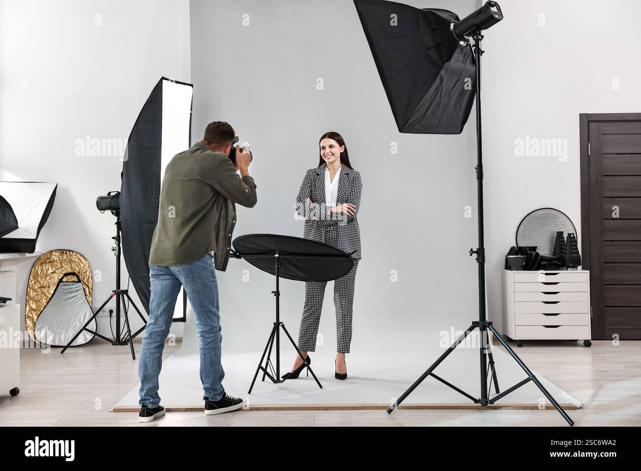 Photographer working with model in professional photo studio Stock ...