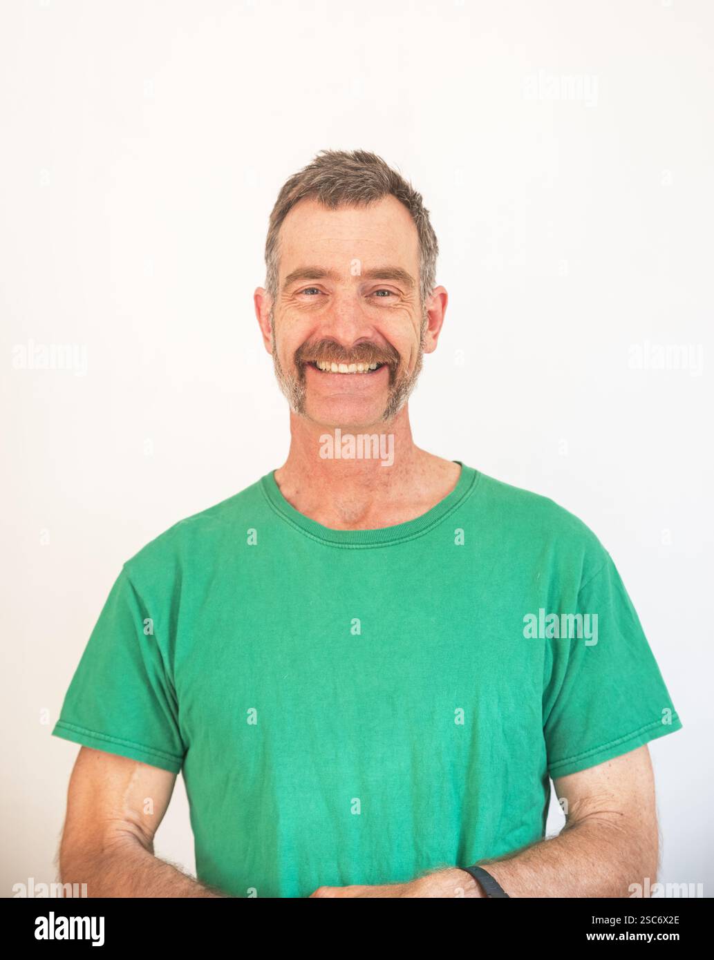 portrait of middle aged white man with friendly mustache and green ...