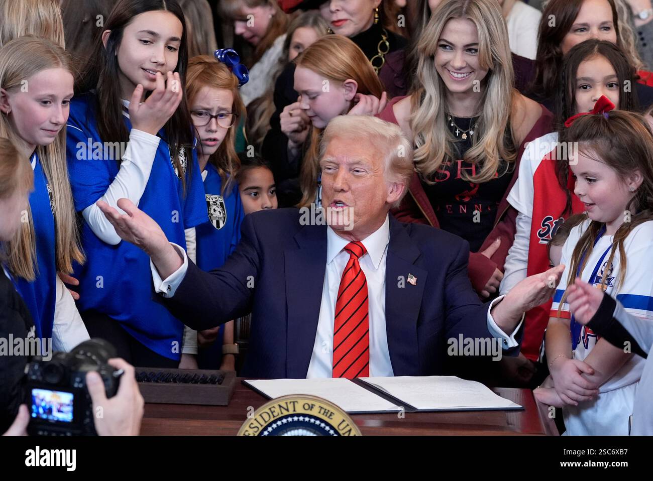 President Donald Trump signs an executive order barring transgender ...