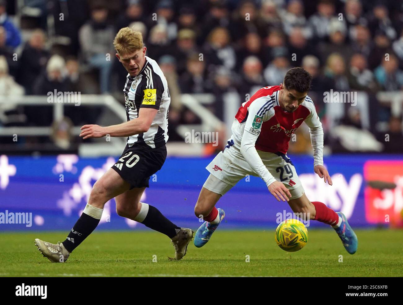 Newcastle United's Lewis Hall (left) and Arsenal's Kai Havertz battle ...