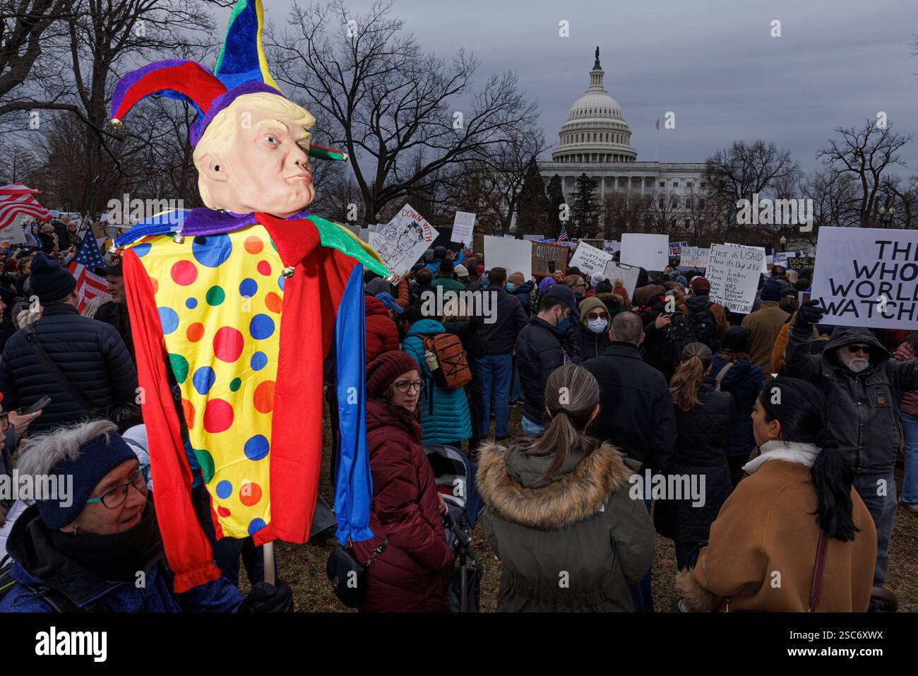 A puppet of Trump in a jester costume is seen as protesters gather ...
