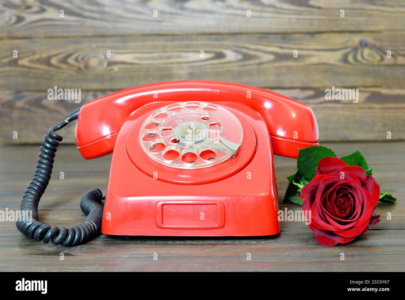 Valentines Day concept. Vintage telephone and red rose Stock Photo - Alamy