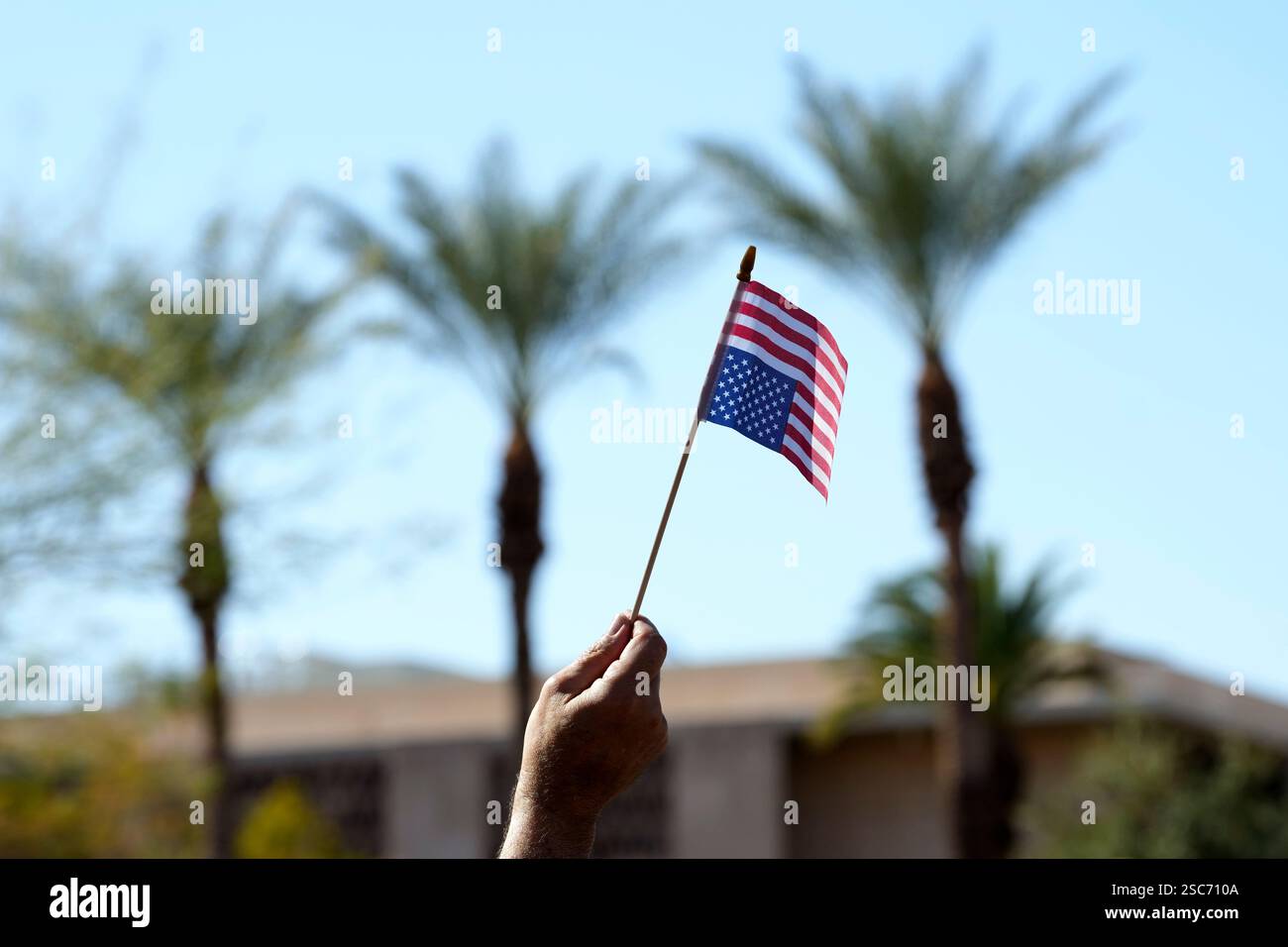 A protester waves an upside down American flag as hundreds gather ...