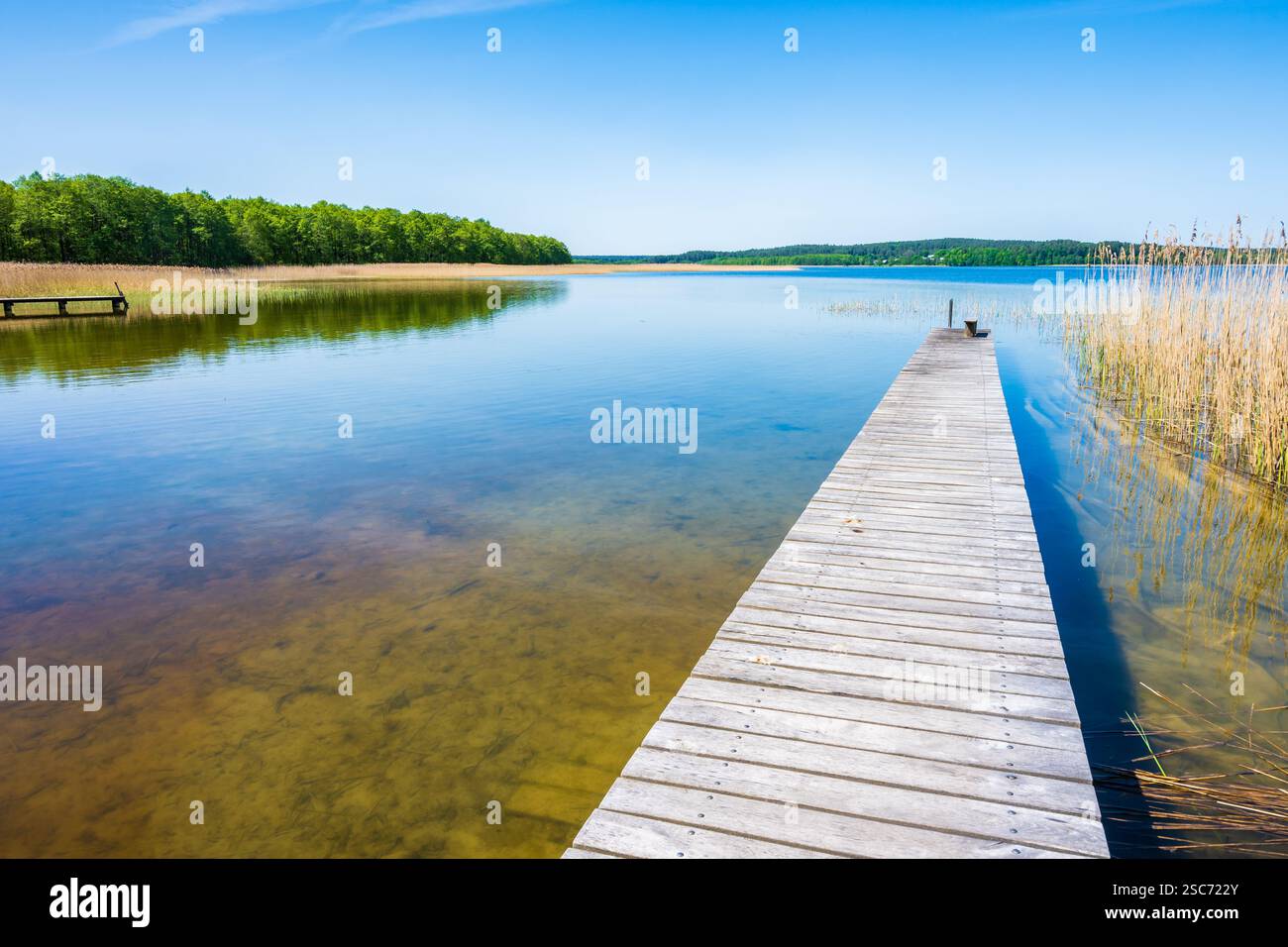 Beach and wooden pier at lake Wigry National Park, Podlasie, Poland ...