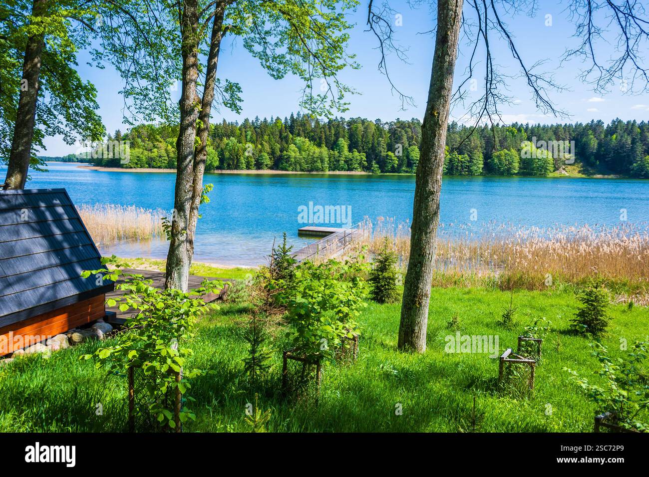 Camping site and view of beach and pier of Wigry lake near Bryzgiel ...