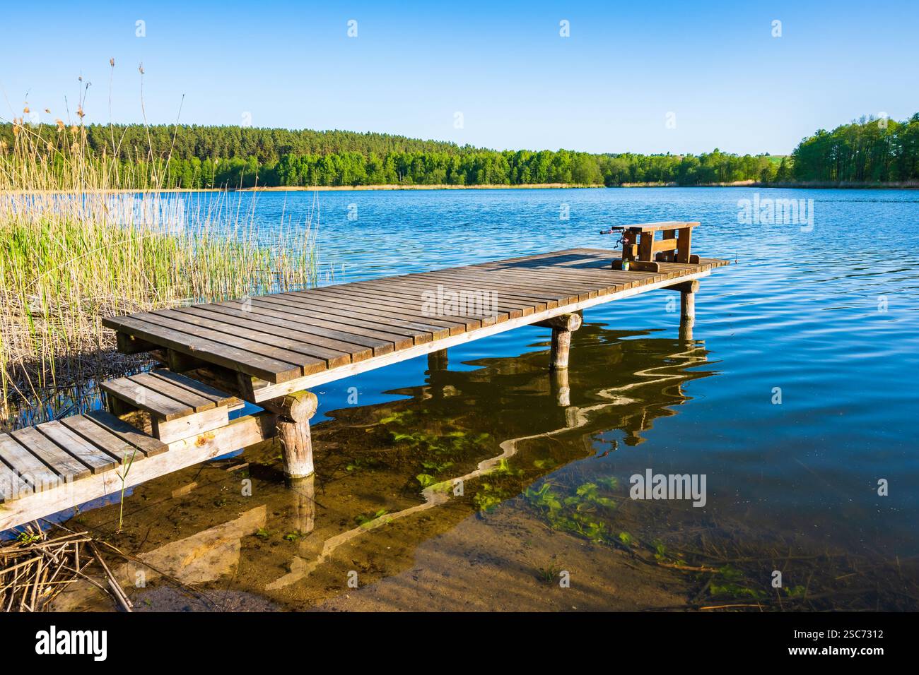 Wooden pier and beach on shore of beautiful lake, Suwalski Landscape ...