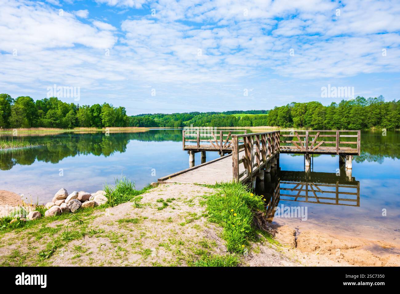 Wooden pier and beach on shore of Pobondzie lake, Suwalski Landscape ...
